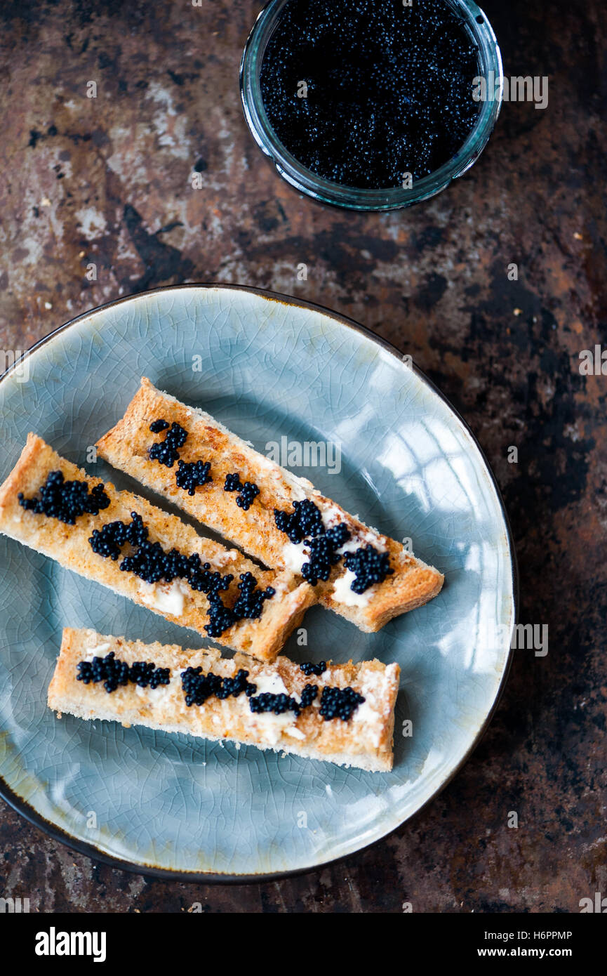 Black caviar on toast with butter Stock Photo - Alamy