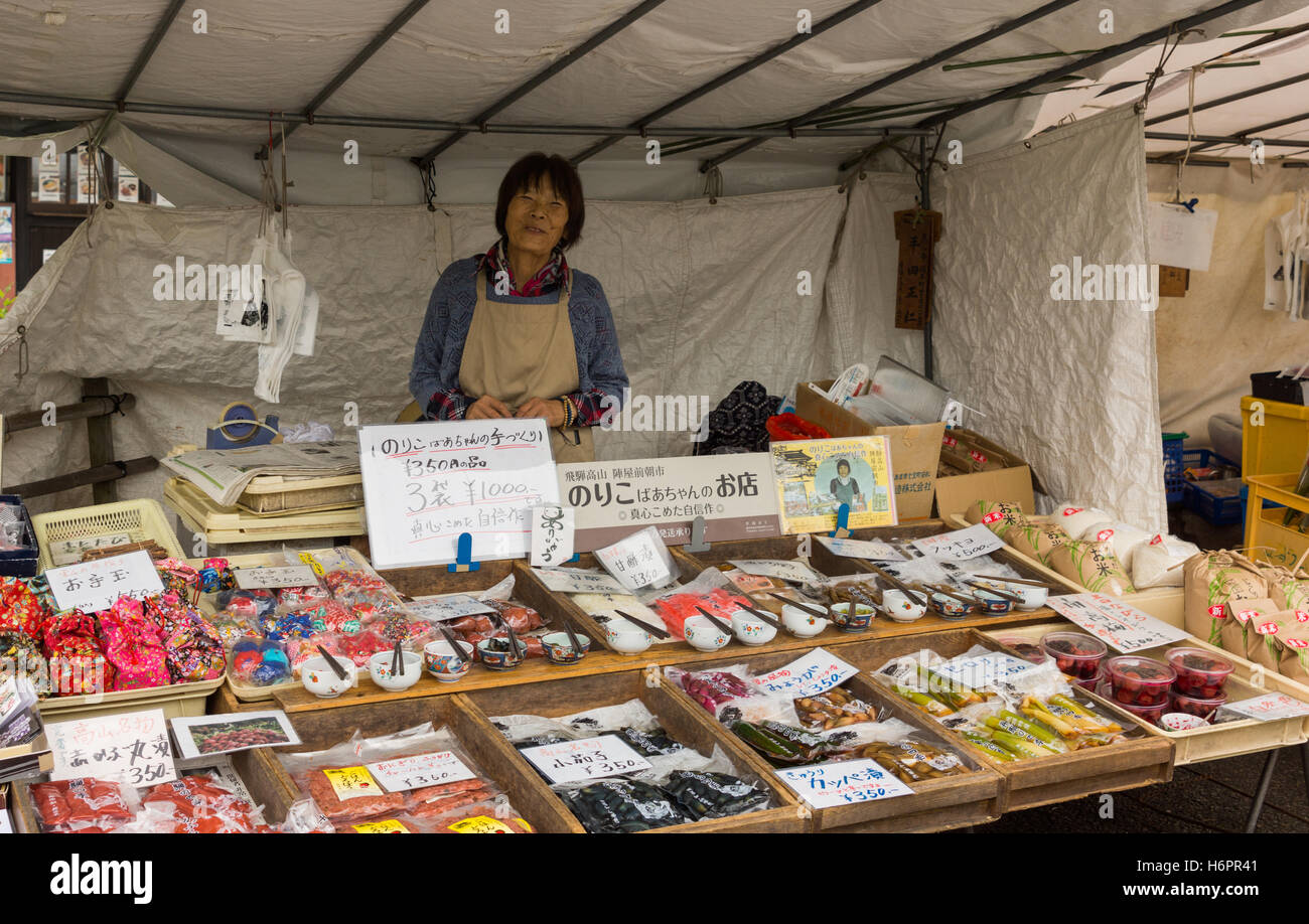 Middle aged Japanese female vendor on street market Stock Photo - Alamy