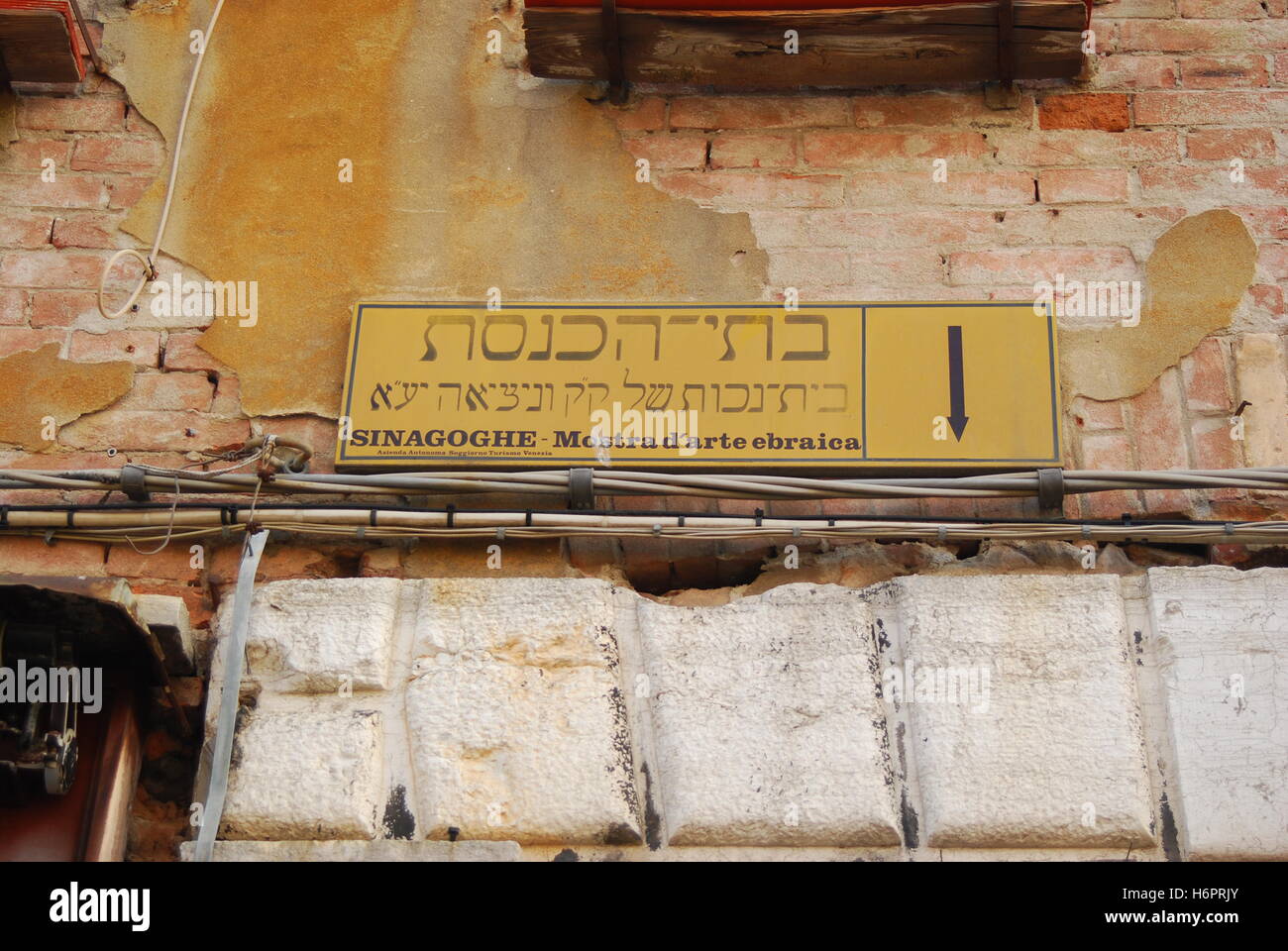 Streetsign on a building's wall indicates way to the synagogue in ...
