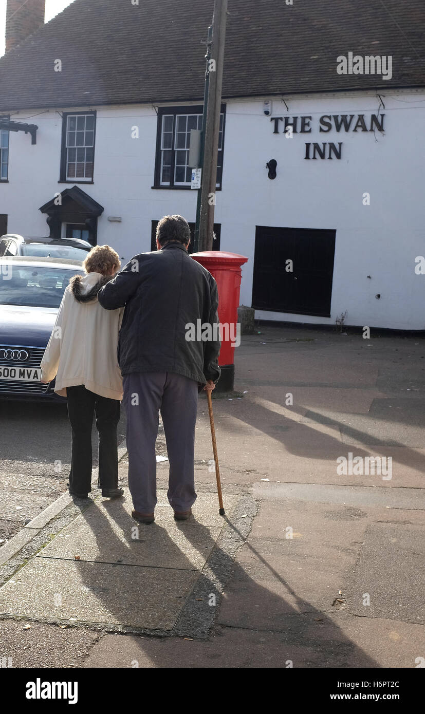 disabled man with walking stick and woman helper in sturry village east ...