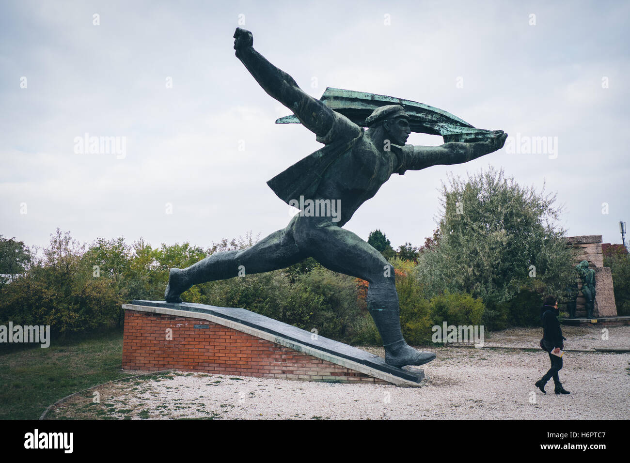 Communist statue Memento Park, Budapest, with tourist Stock Photo - Alamy