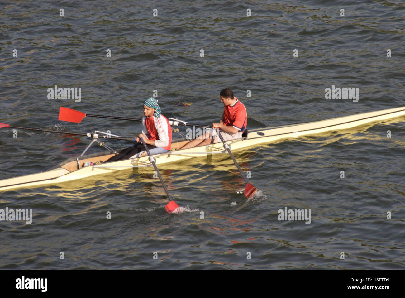 A Canoe on the river Nile with 2 people rowing Stock Photo - Alamy