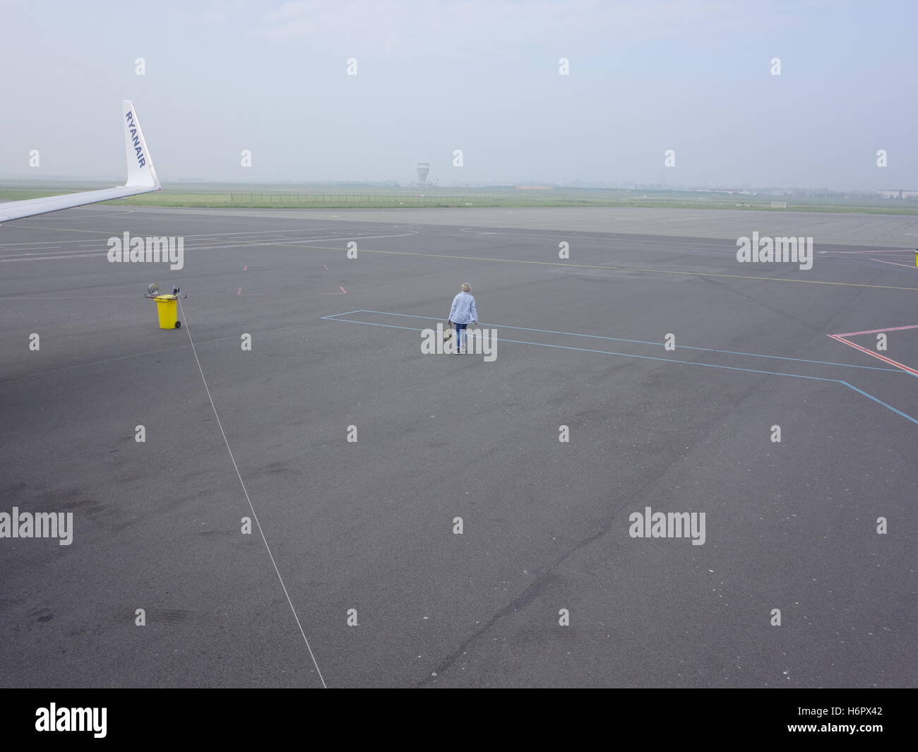 A lady is standing in the middle of a runway before takeoff Stock Photo ...