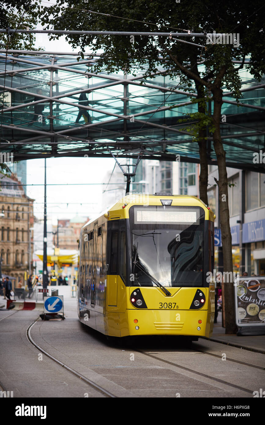 Manchester tram landmark cross street Metrolink yellow stopped glass ...