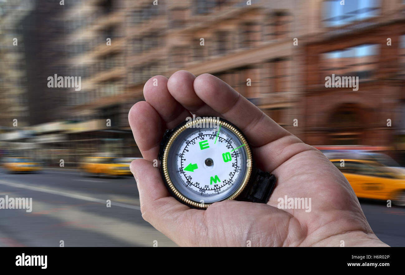 Navigating in the city with a compass in hand Stock Photo - Alamy
