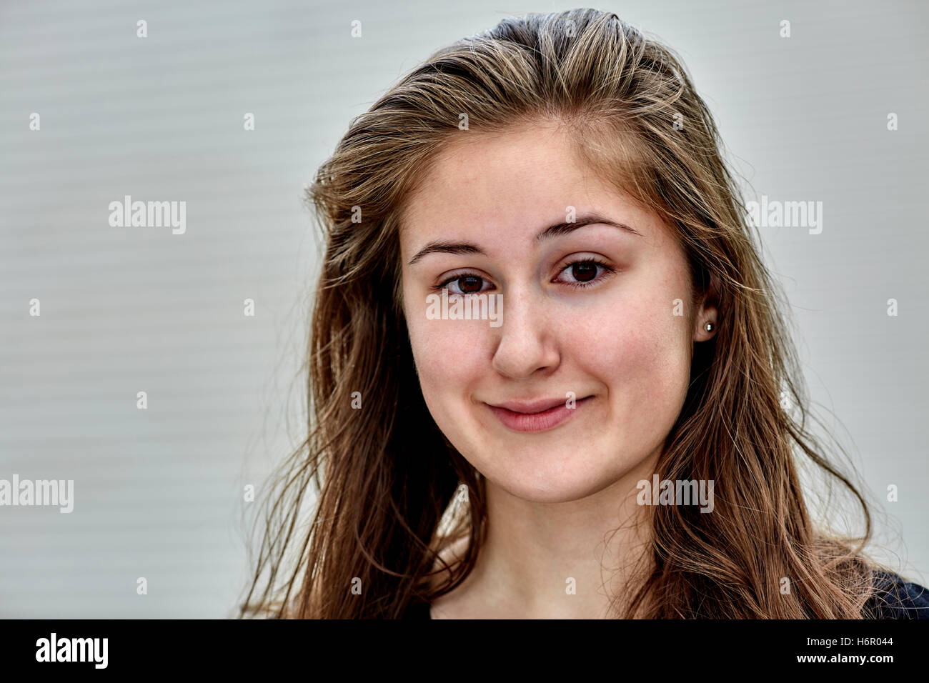 Young woman smiling happily Stock Photo - Alamy