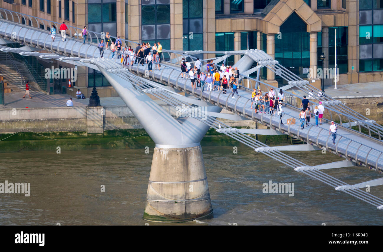 People walking over the Millennium Bridge in London - aerial view Stock ...