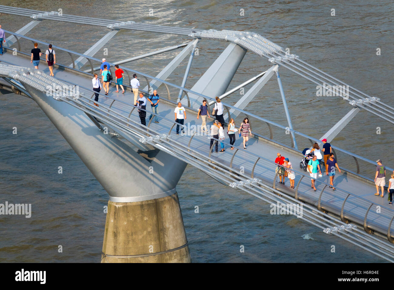 People walking over the Millennium Bridge in London - aerial view Stock ...