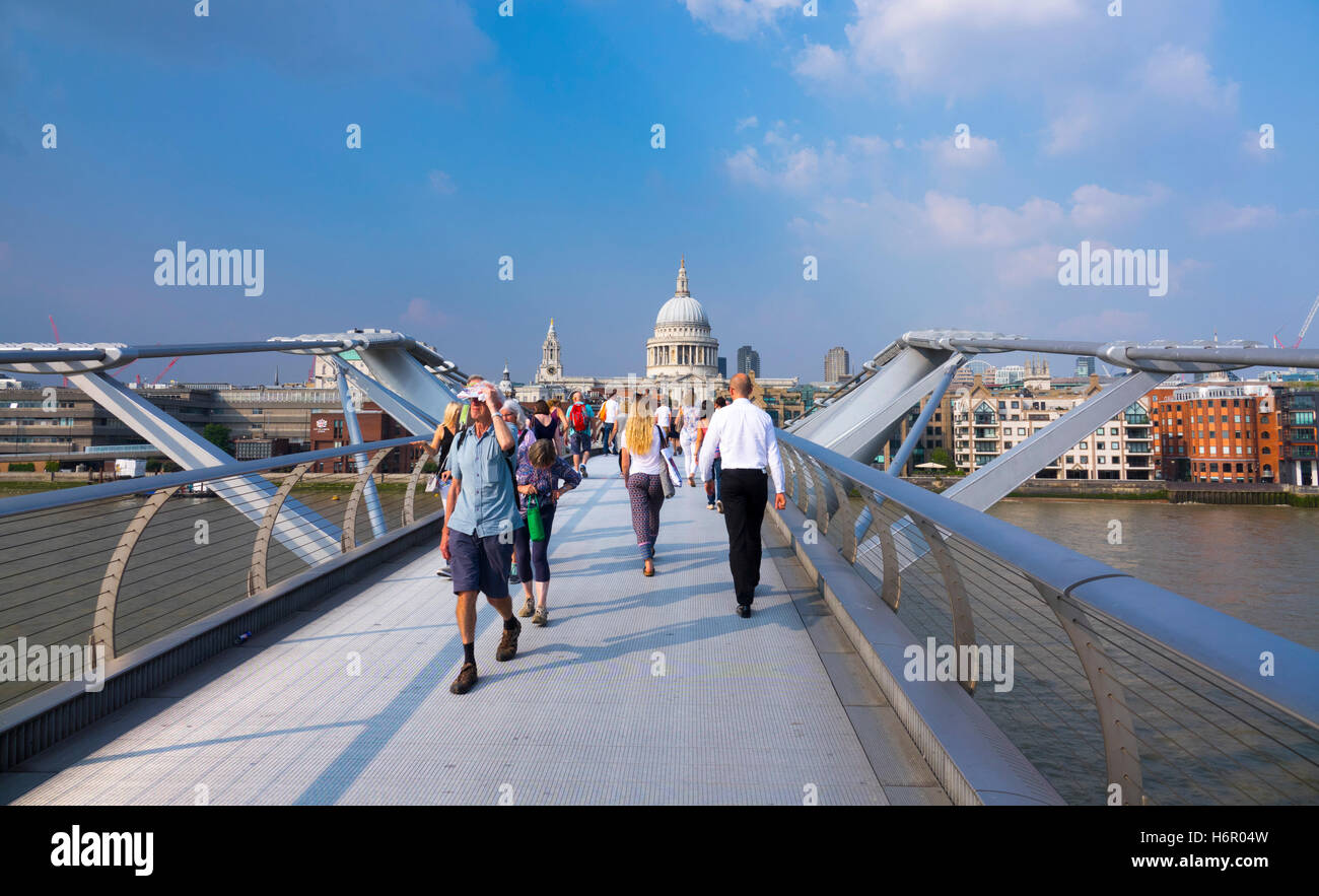 People walking over the Millennium Bridge in London Stock Photo - Alamy