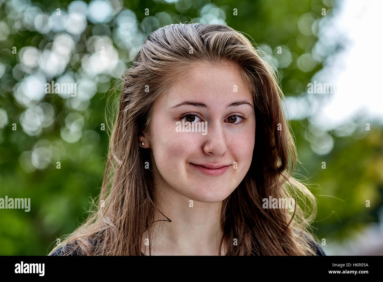 Young woman happily smiling Stock Photo - Alamy