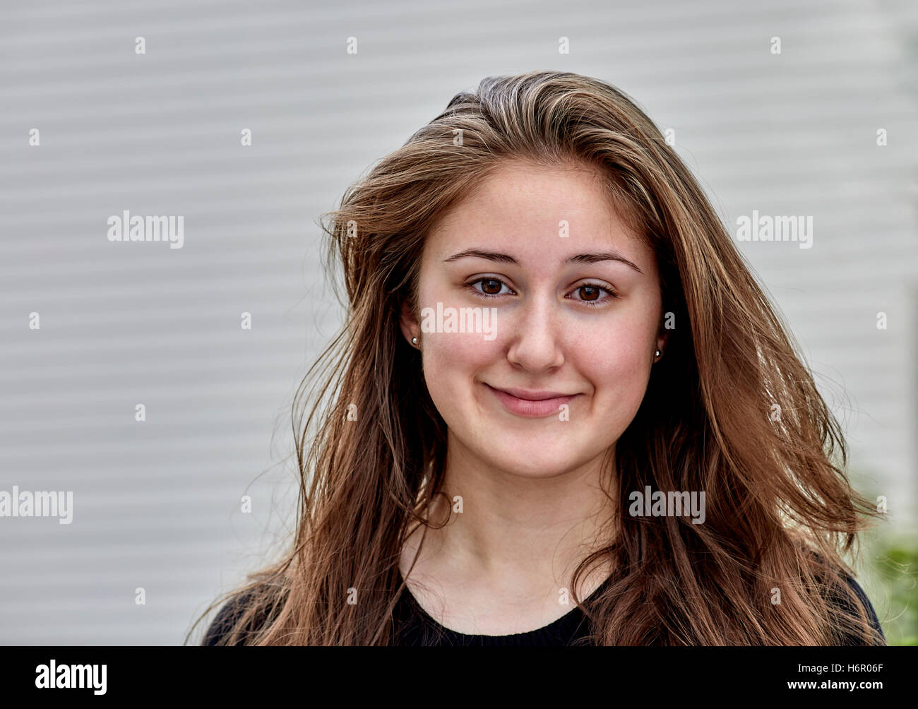 Young woman smiling happily Stock Photo - Alamy