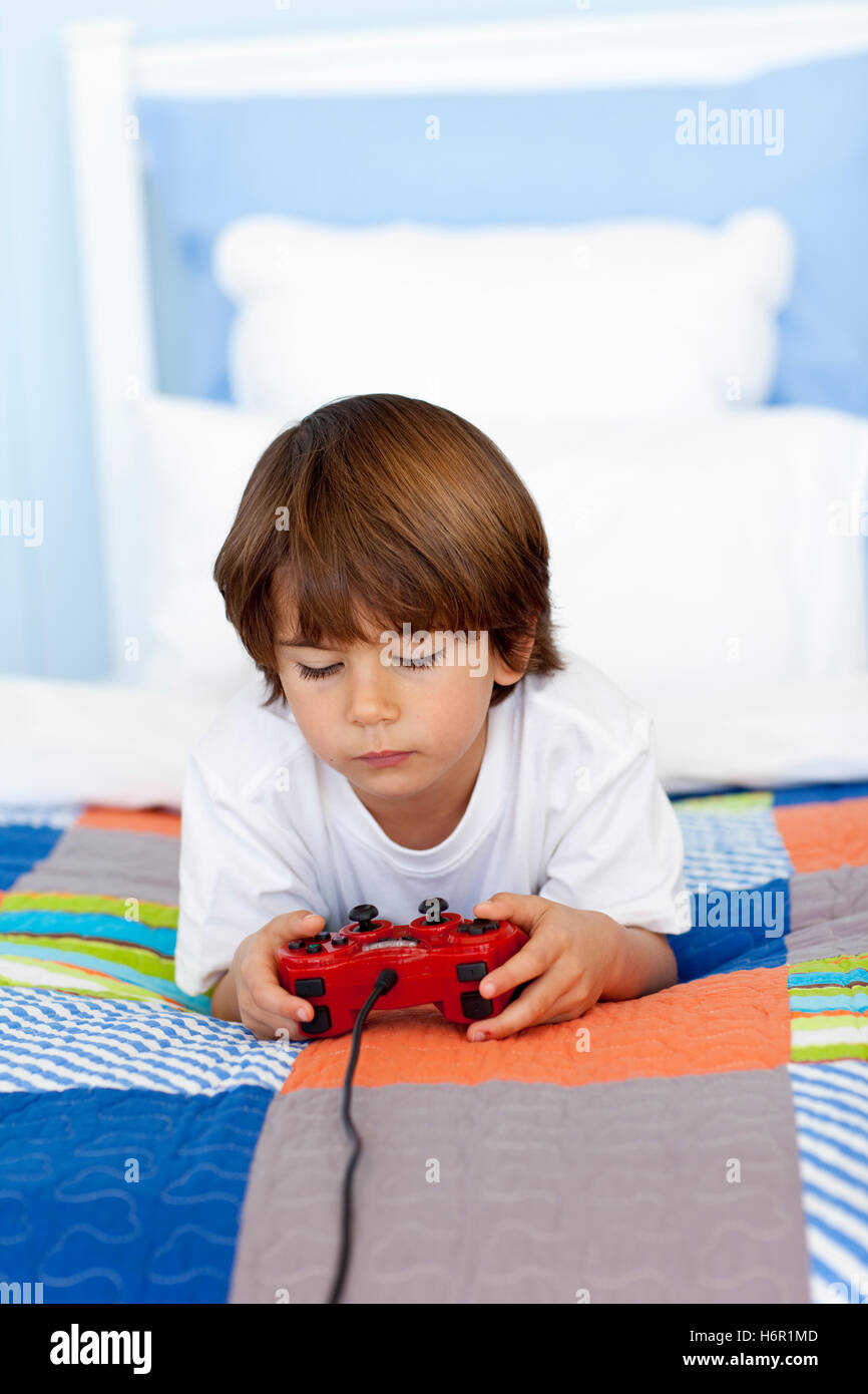 Little boy playing videogames in his bedroom Stock Photo - Alamy