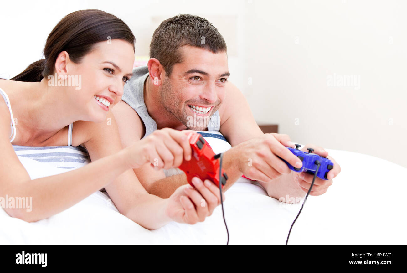 United couple playing video games against a white background Stock ...