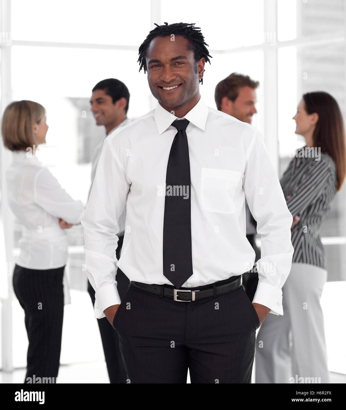 African male manager with his team in a office Stock Photo - Alamy
