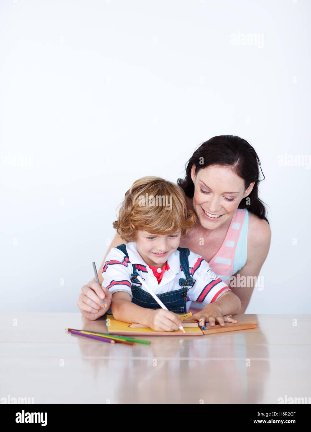 Young family draw a picture against white background Stock Photo - Alamy