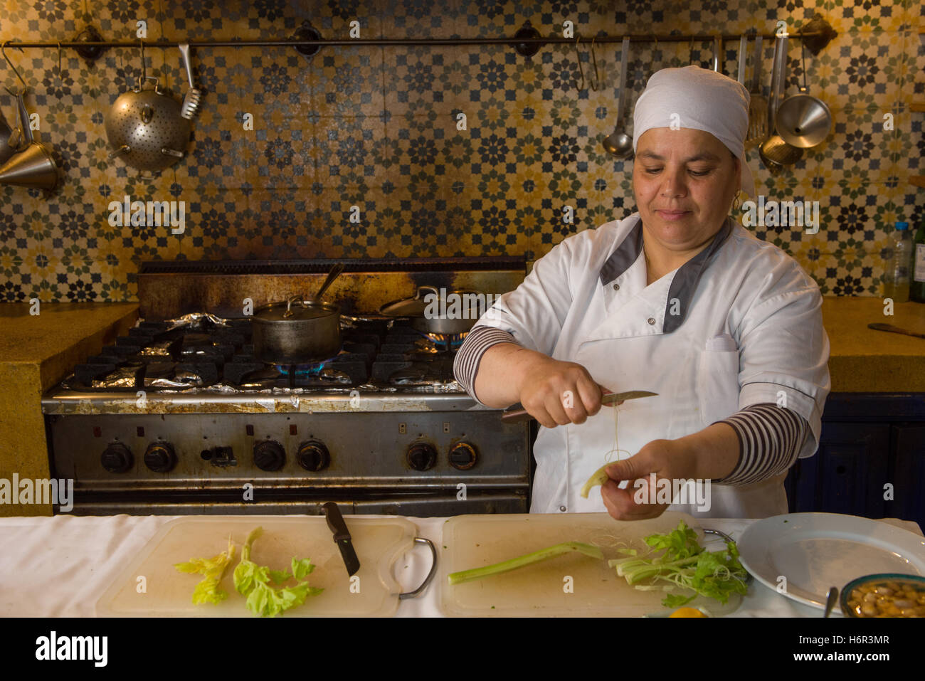 Fatna, traditional dada (traditional female chef) in the kitchen at the Riad Kaiss, preparing ...