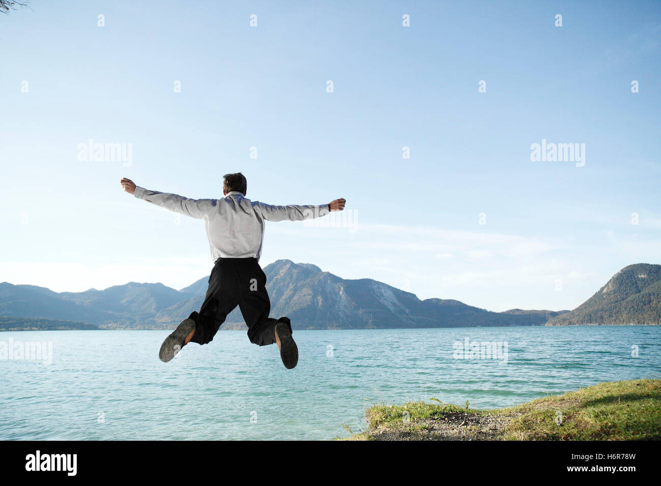 Blue symbol person jumping hi-res stock photography and images - Alamy