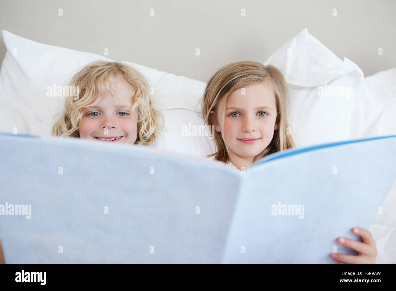 Brother and sister reading bedtime story together Stock Photo - Alamy