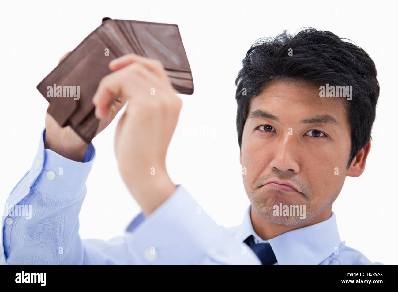 Businessman showing his empty wallet against a white background Stock ...