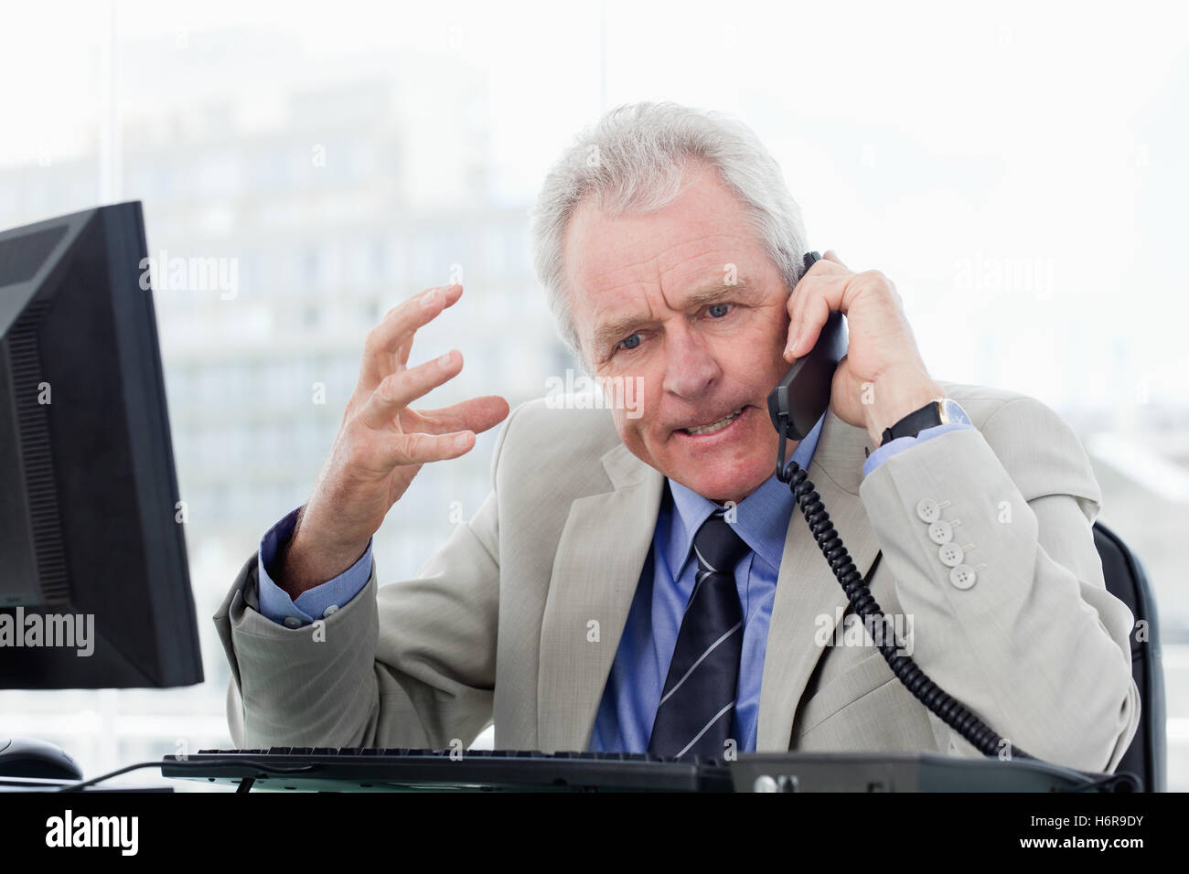Angry senior manager on the phone in his office Stock Photo - Alamy