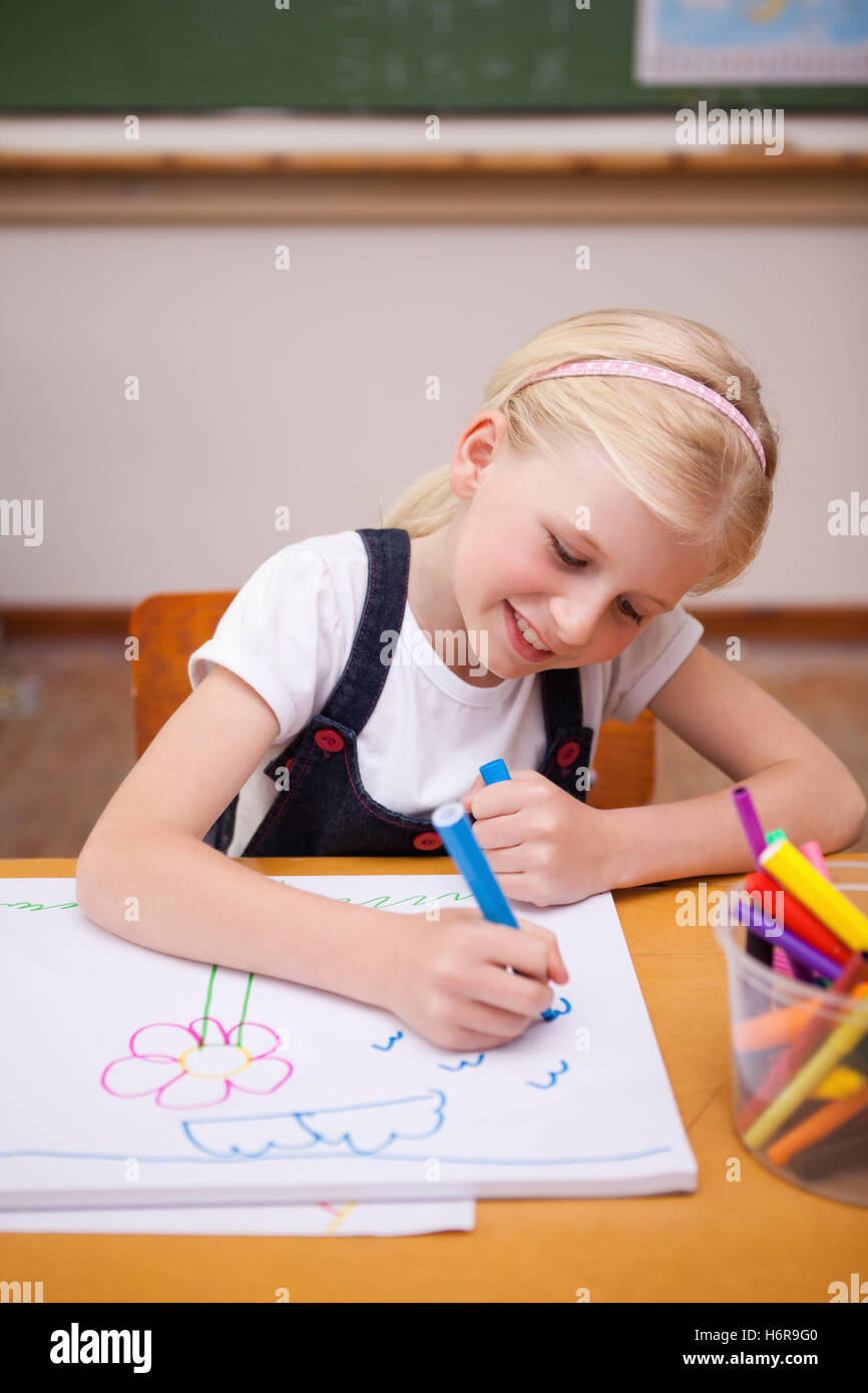 Portrait of a girl drawing in a classroom Stock Photo - Alamy