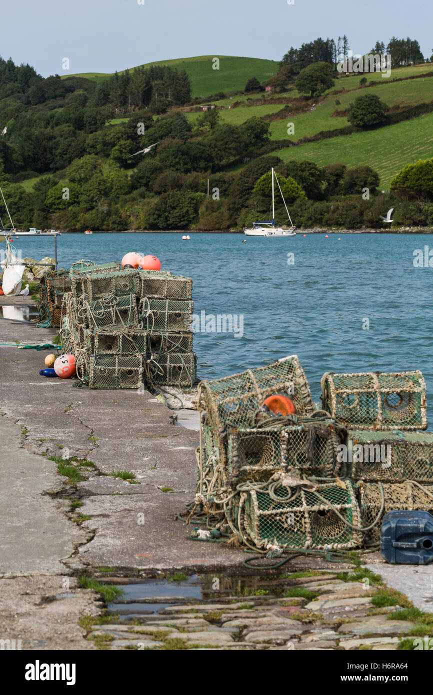 Lobster pots piled up on the quayside at Union Hall fishing village in ...