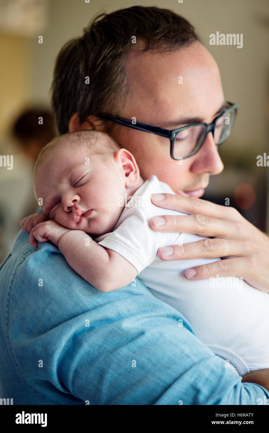 Close up of young father holding his newborn baby son Stock Photo - Alamy