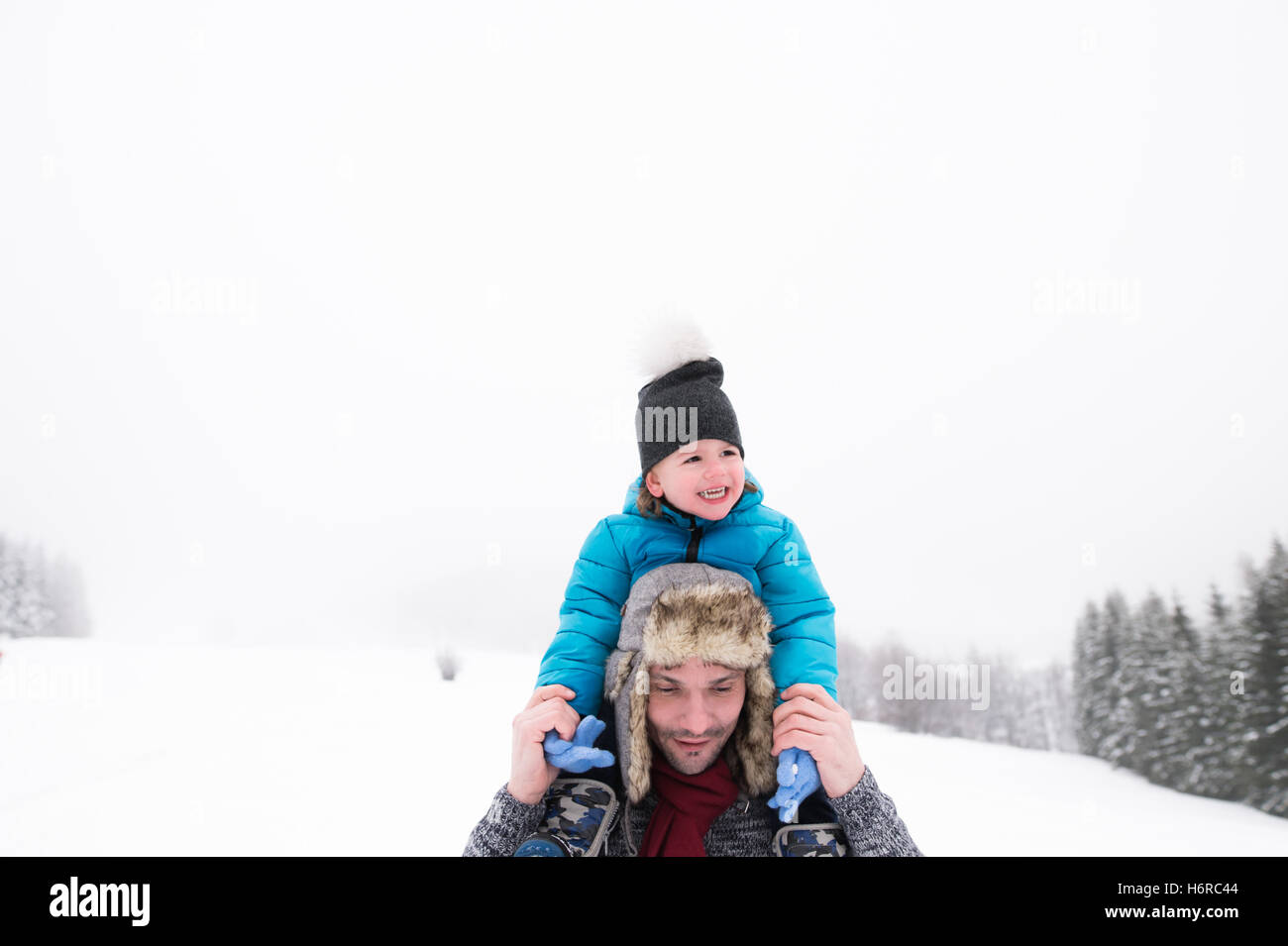 Father giving his son piggyback. Winter nature Stock Photo - Alamy