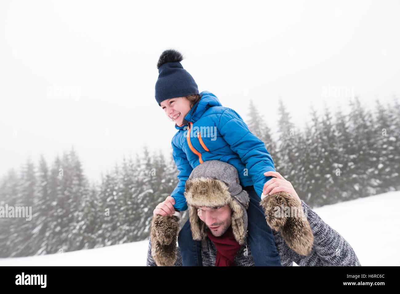 Father giving his son piggyback. Winter nature Stock Photo - Alamy