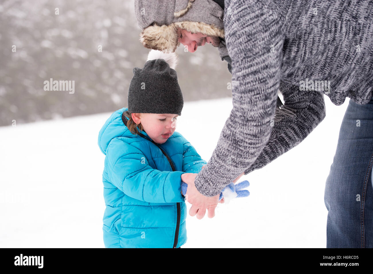 Young father with his son, playing in the snow Stock Photo - Alamy