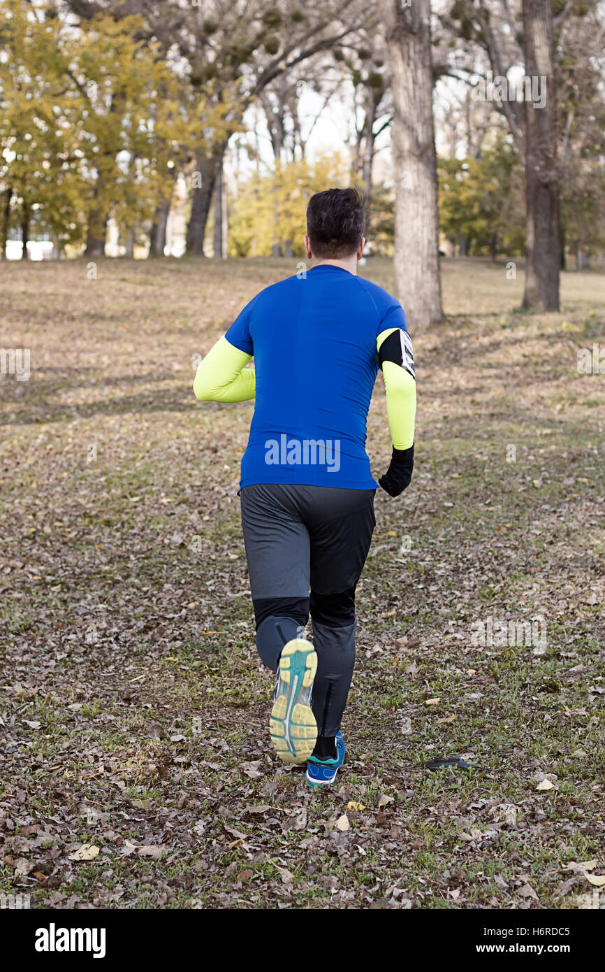 Athletic young man running in the nature. Healthy lifestyle Stock Photo ...