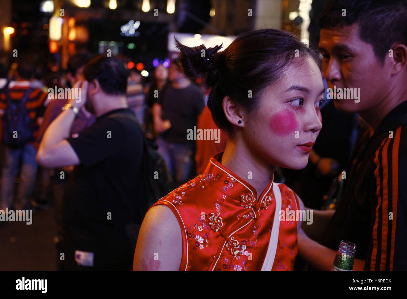 A girl dressed as Chinese female ghost walk the street of Lam Kwai Fong ...