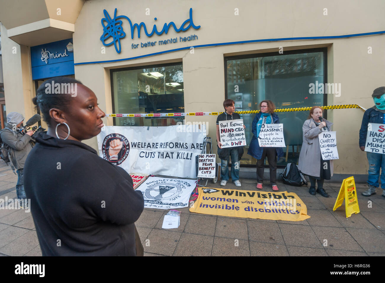 London, UK. 31st October 2016. A woman stops to listen as the Mental ...