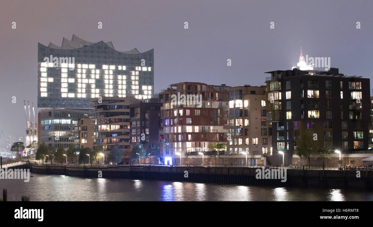 With several illuminated windows, the facade of the Elbphilharmonie ...