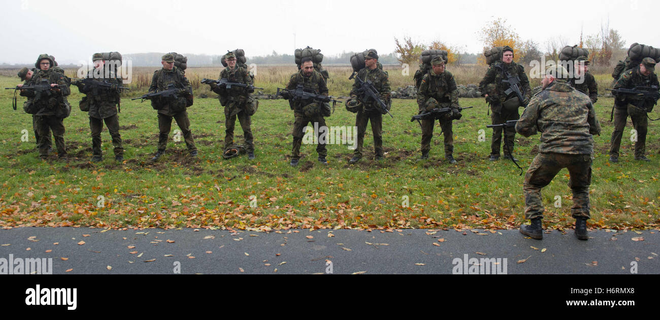 Soldiers receiving basic training stand on the premises of the ...