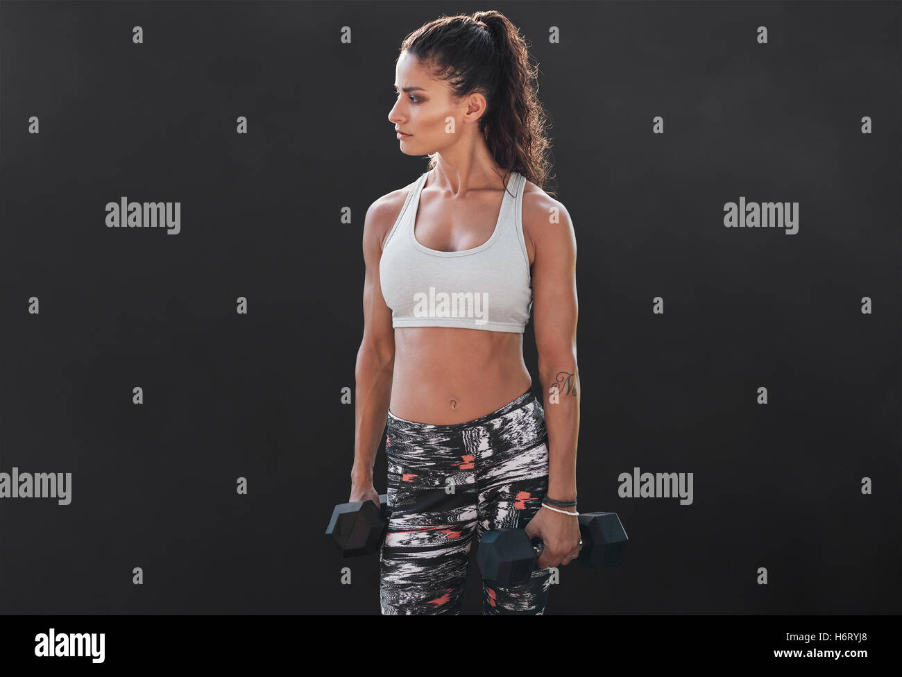 Slim and fit woman lifting hand weights. Muscular female working out ...