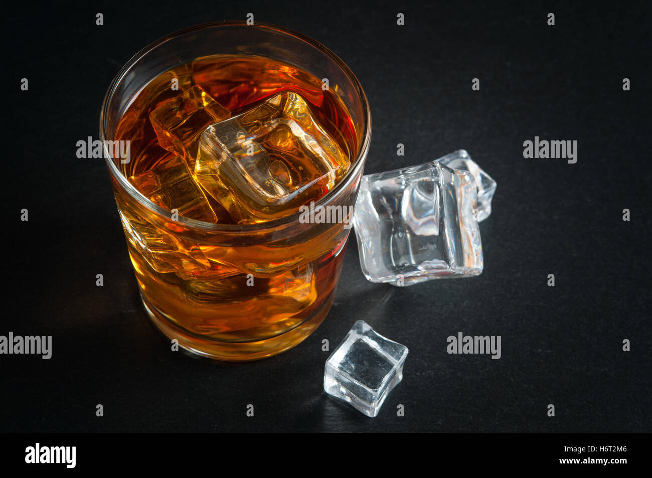 Whiskey with ice cubes Stock Photo - Alamy