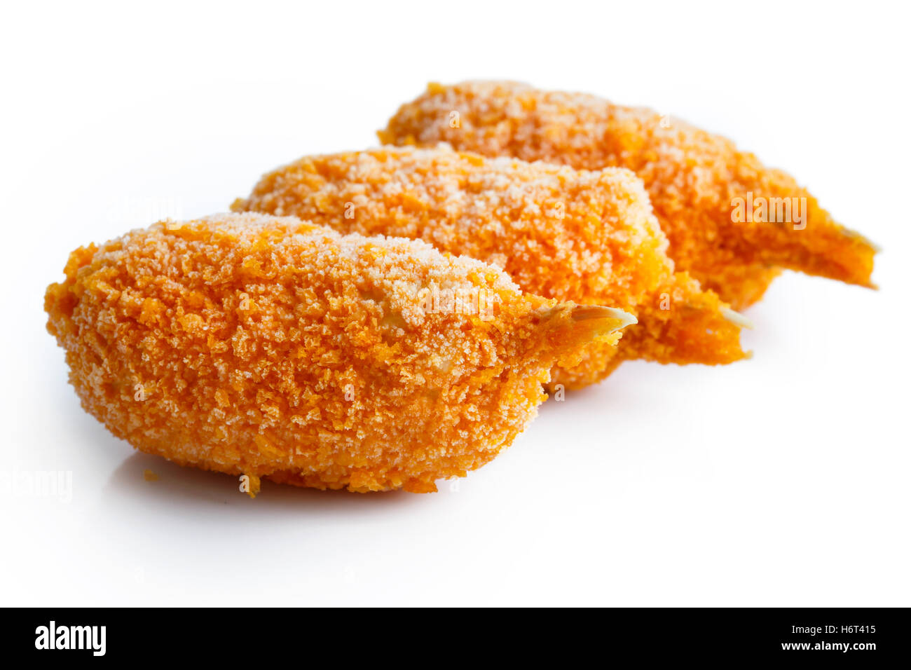 Three frozen breaded surimi crab claws in perspective, isolated on ...