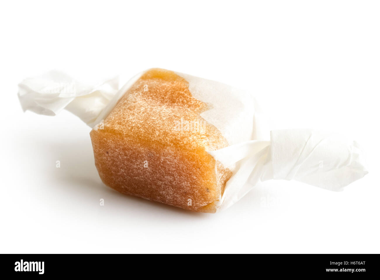 SIngle luxury wrapped caramel toffee isolated on white in perspective ...