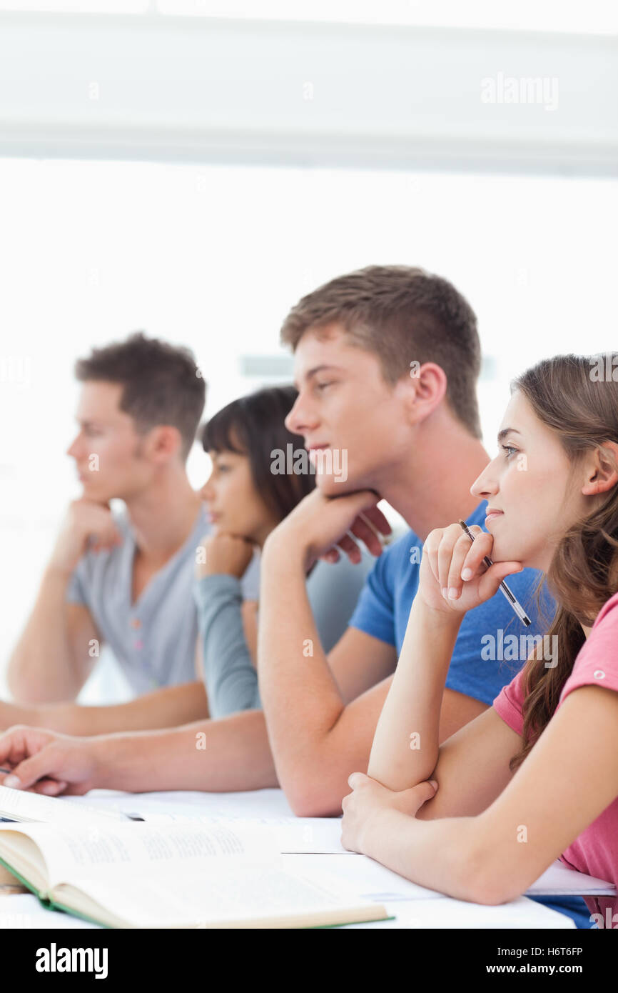 A group of students in class with one student looking a bit tired Stock ...