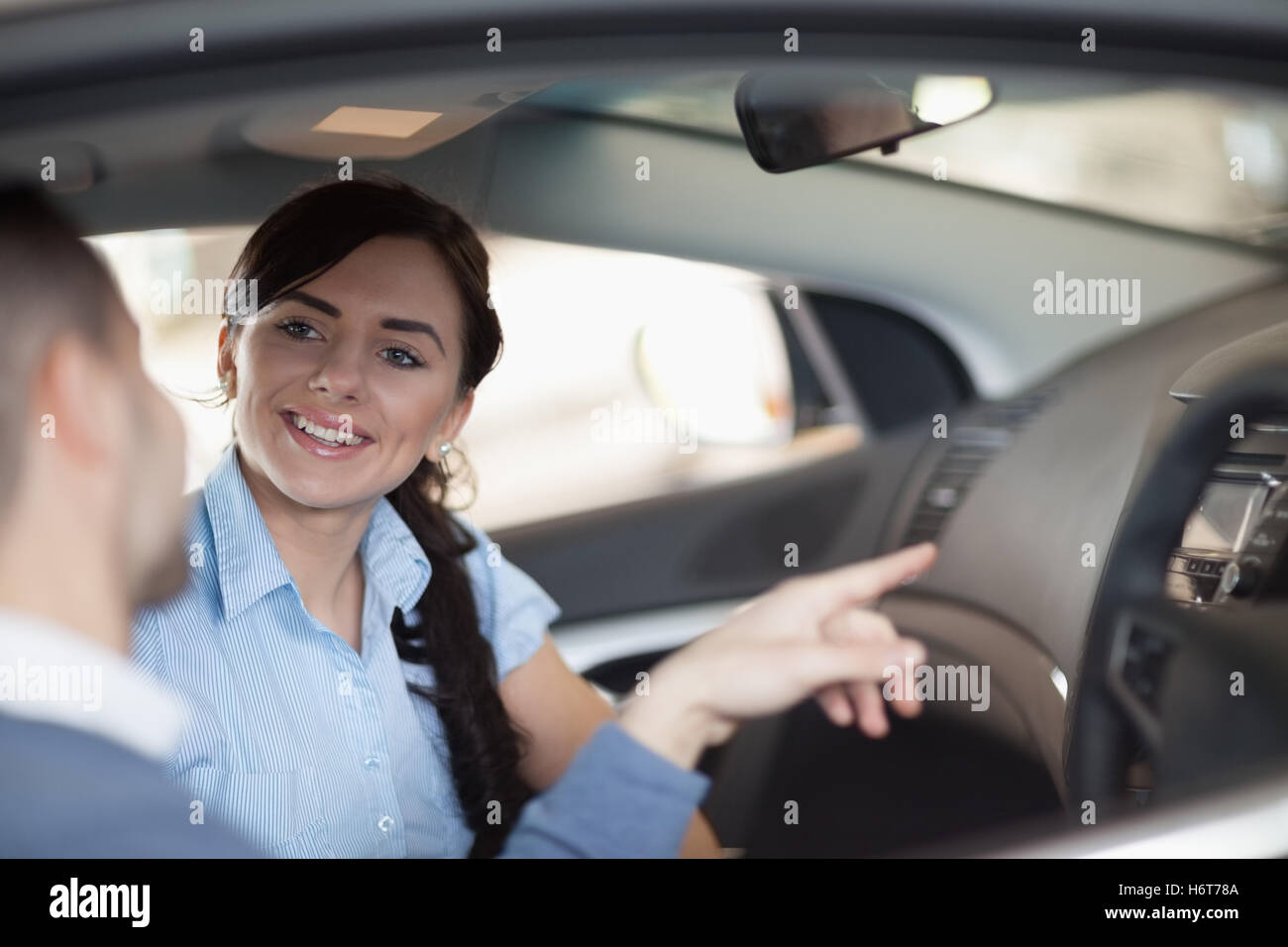Happy young woman car pointing finger hi-res stock photography and ...