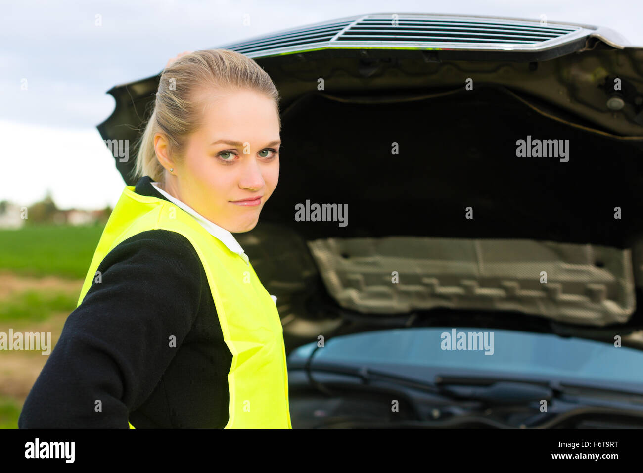 young woman with open bonnet on street Stock Photo - Alamy