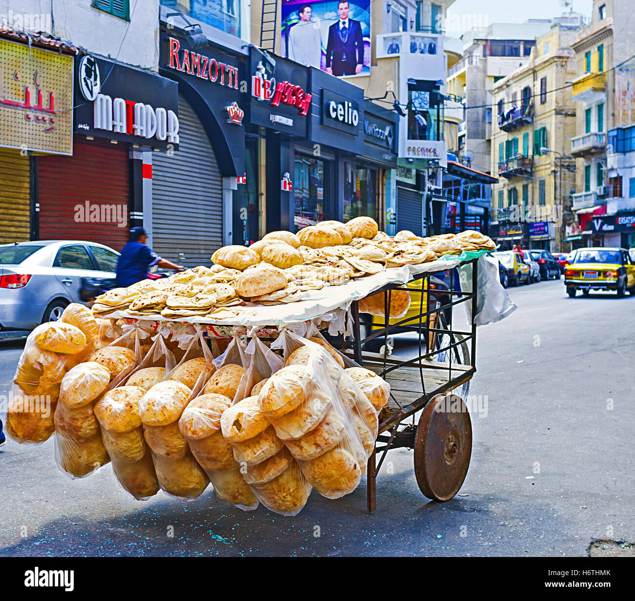 The old cart with the flat bread stands in the middle of the shopping ...
