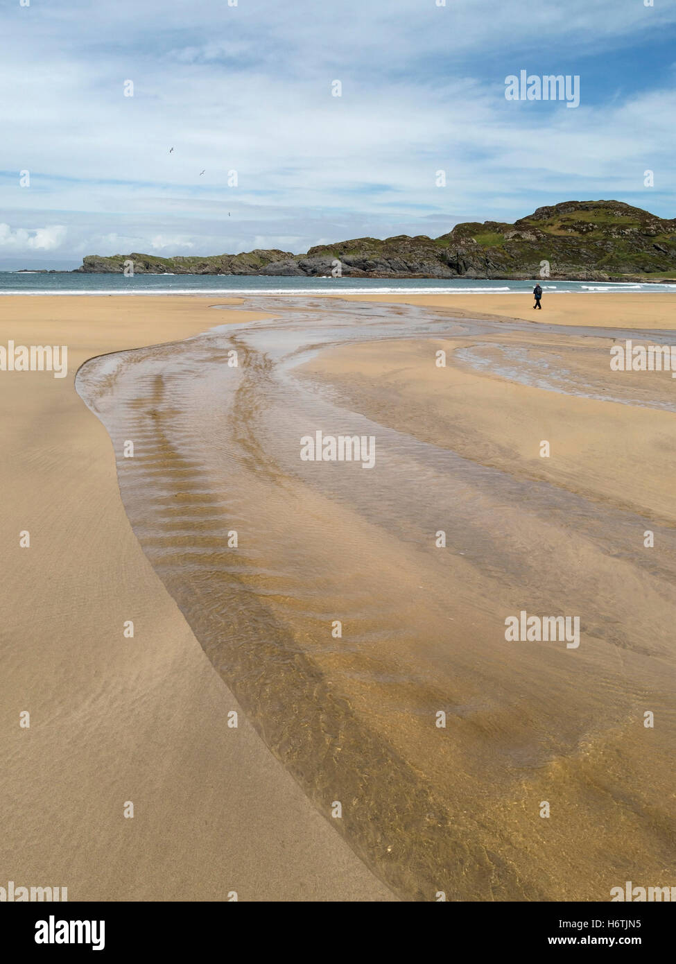 Lone figure on remote sands of Kiloran Bay Beach, Hebridean Island of ...