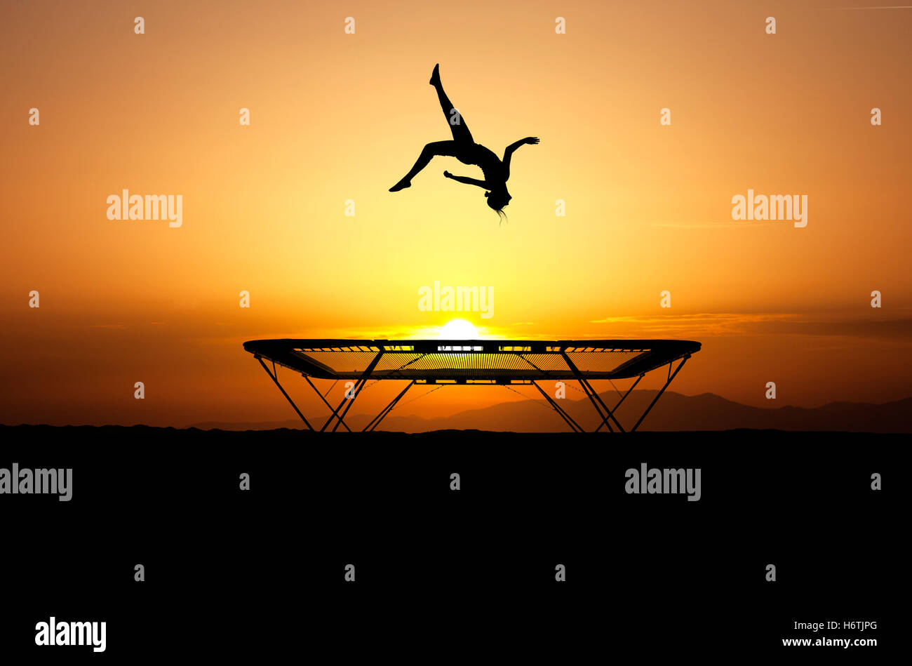 trampolining at sunset Stock Photo - Alamy