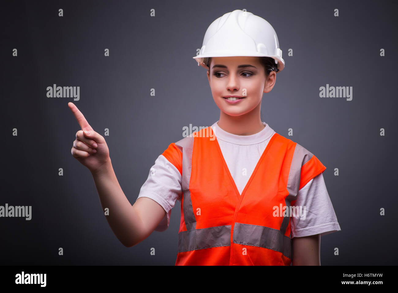 Cute construction worker pressing virtual buttons Stock Photo - Alamy