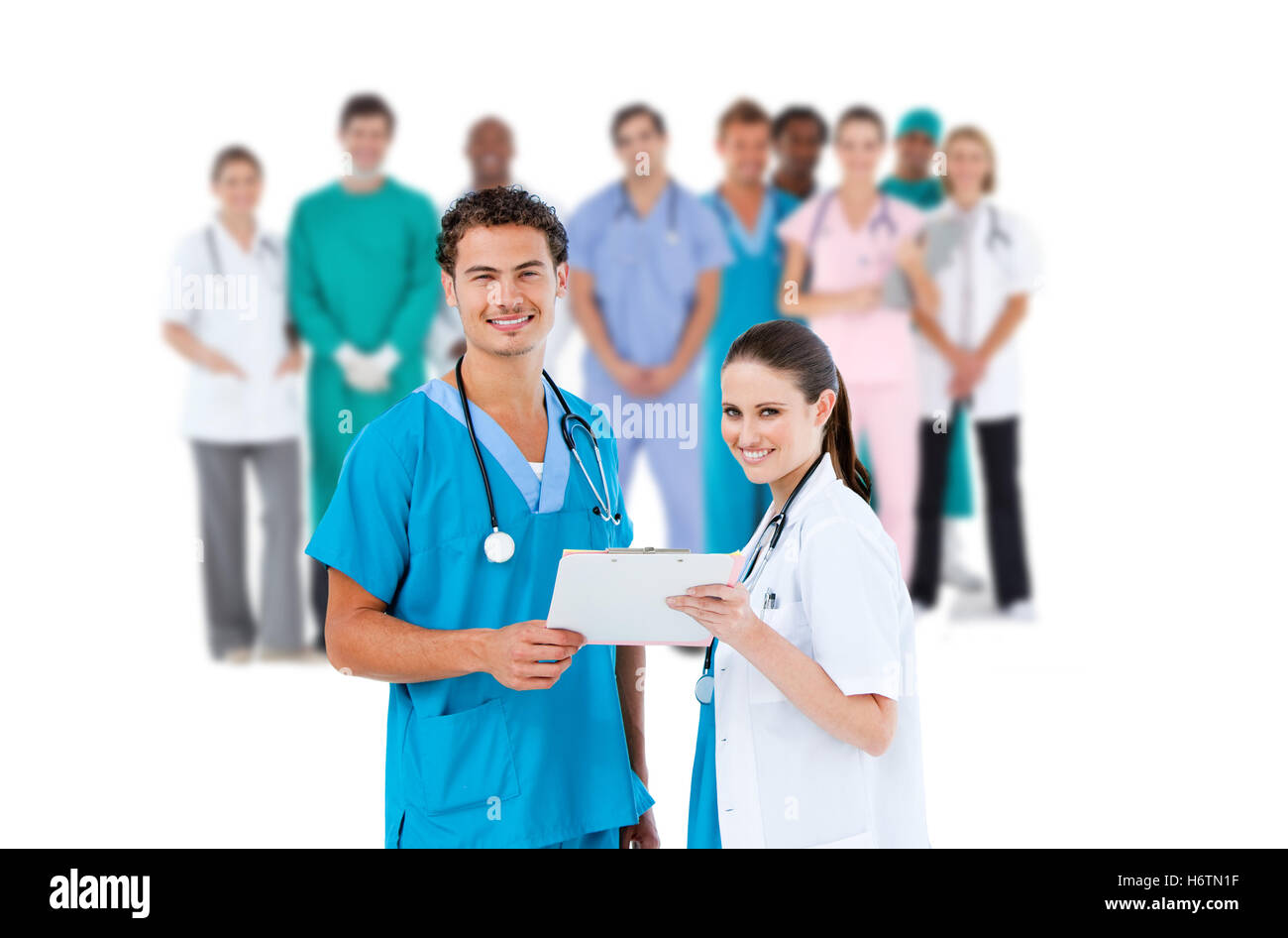 Nurse and doctor holding clipboard and smiling with medical staff ...