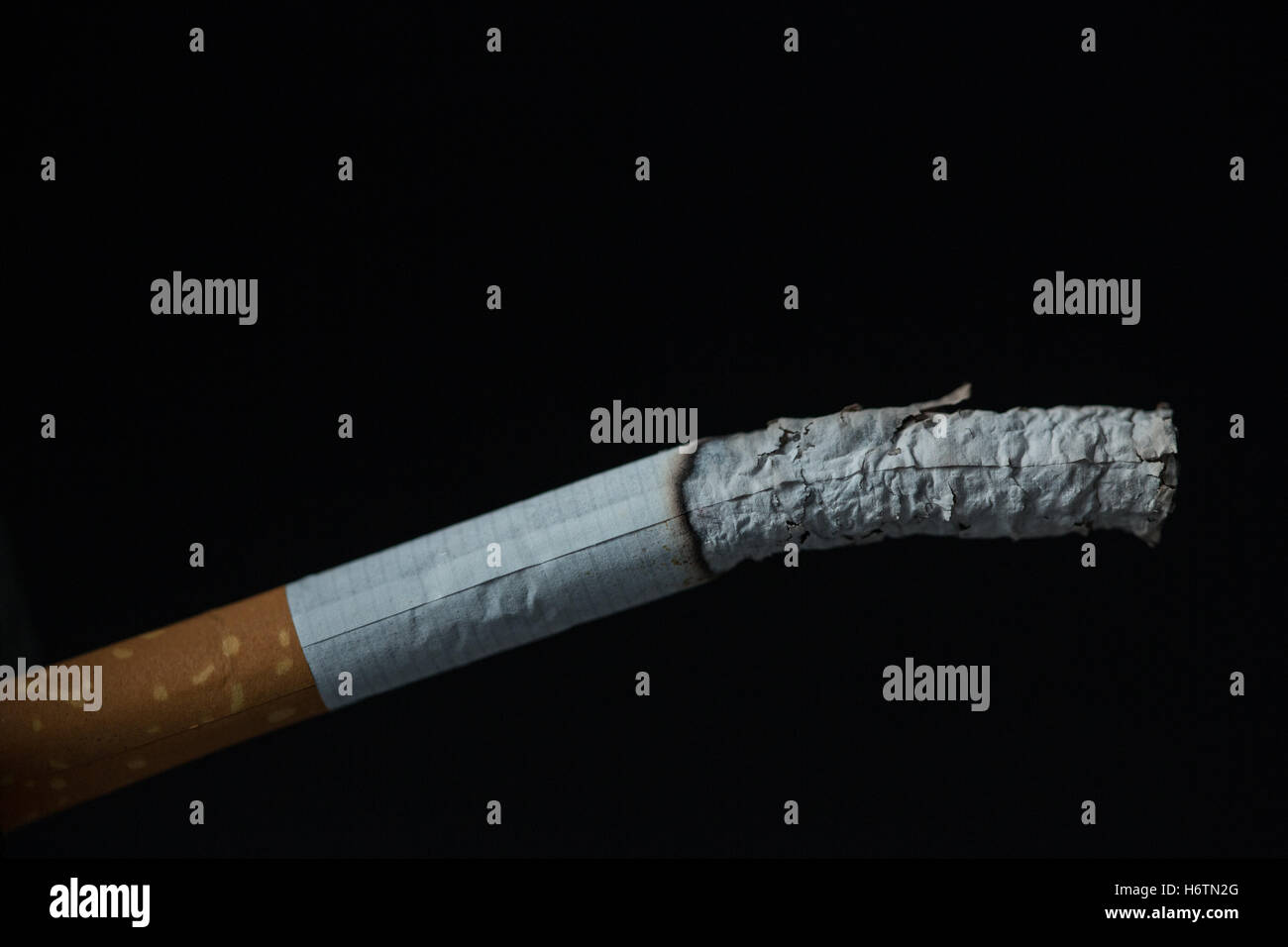 Burning cigarette close up on black background Stock Photo - Alamy