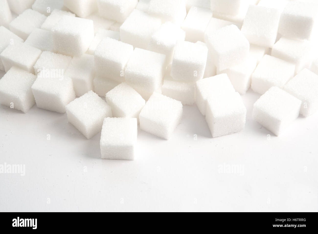 Sugar lumps stacked against a white background Stock Photo - Alamy