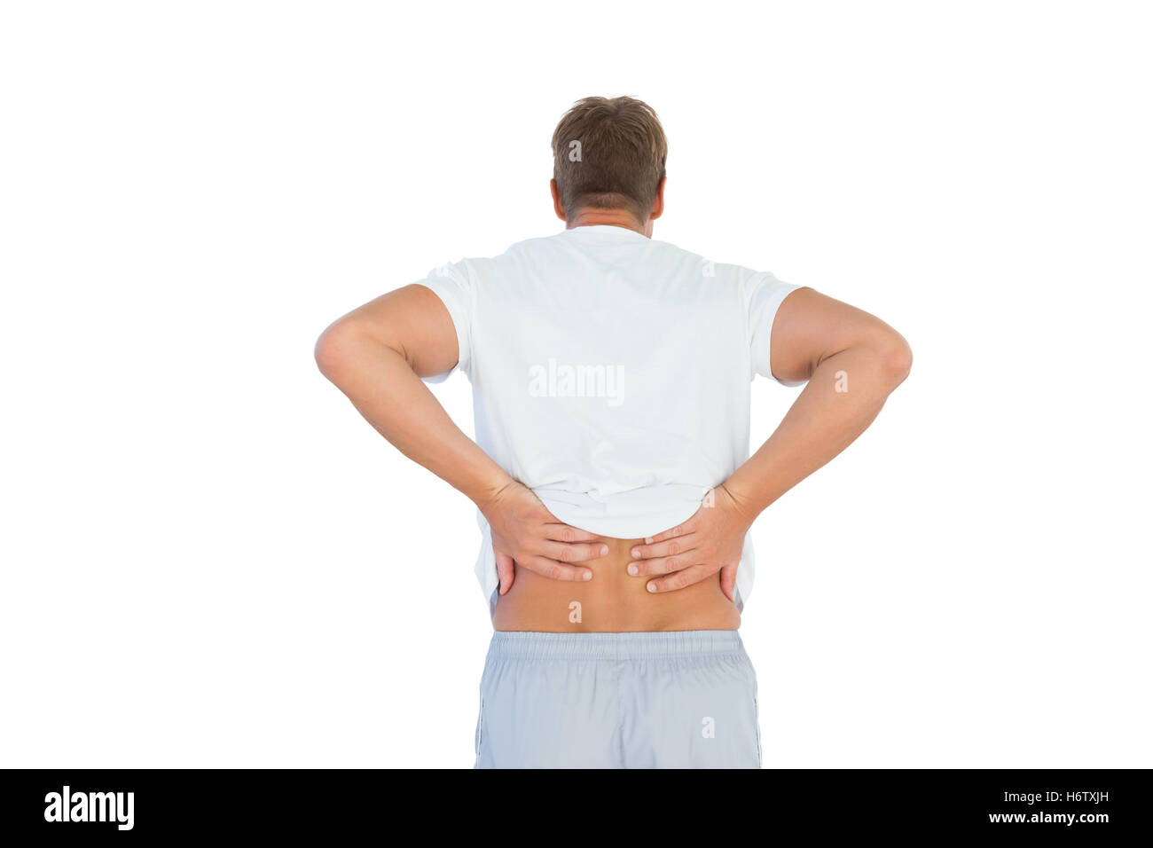 Muscled man suffering from back pain on white background Stock Photo ...